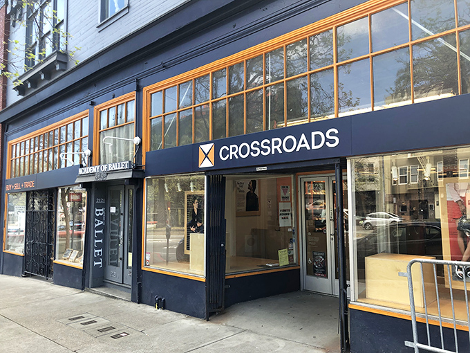 The navy blue storefront with orange-trimmed windows stands like a fashion oasis on Market Street, beckoning style-seekers with promises of hidden treasures inside.