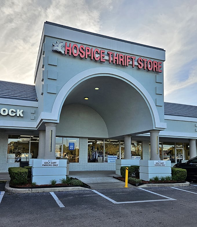 The iconic archway entrance beckons bargain hunters like a retail Narnia portal. Blue skies above promise good fortune within.