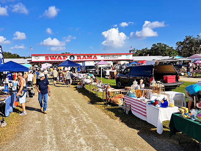 The colorful entrance to Swap-O-Rama beckons treasure hunters with its rainbow of vendor stalls and promise of discoveries waiting just beyond those pastel sheds.