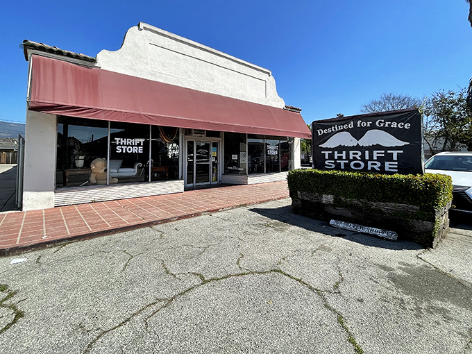 Classic California architecture meets thrift store magic under that distinctive red awning&mdash;where the real treasures await just beyond those glass doors.