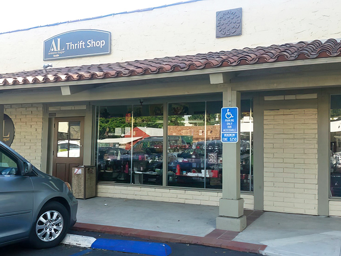 The unassuming storefront of Assistance League of Tustin Thrift Shop &ndash; where treasure hunting begins beneath that classic Spanish-style roof.