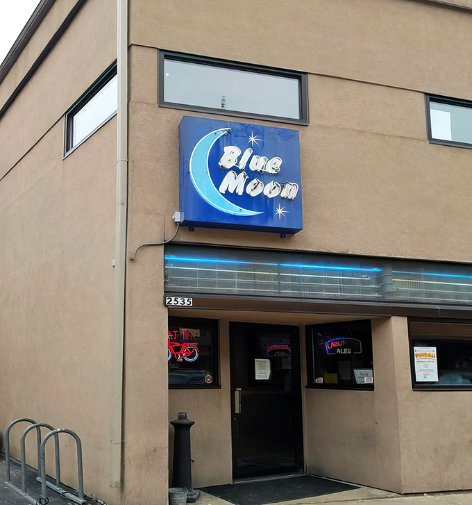 The unassuming exterior of Blue Moon Bar & Grill stands like a culinary speakeasy, its blue neon sign a beacon for those in-the-know seeking Wisconsin's finest cheese curds.