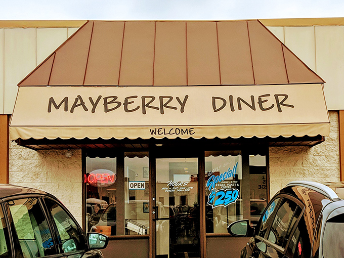 The iconic copper-toned awning of Mayberry Diner beckons hungry travelers like a breakfast lighthouse guiding ships to syrupy shores.