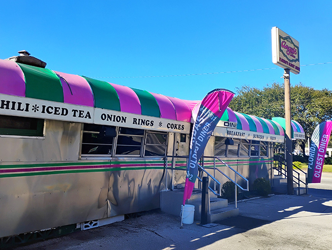 The pink and green striped awning of Angel's Dining Car isn't just eye-catching&mdash;it's a beacon of hope for hungry travelers seeking authentic diner magic in Palatka.