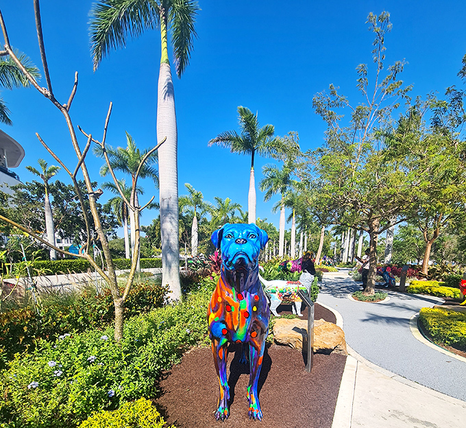 A blue dog with vibrant graffiti-style artwork stands sentinel under Miami's impossibly blue sky, like a canine guardian of joy.