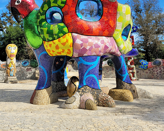 The technicolor dream coat of sculptures! Queen Califia's eagle-throne stands tall, a kaleidoscopic sentinel guarding this whimsical wonderland in Escondido.
