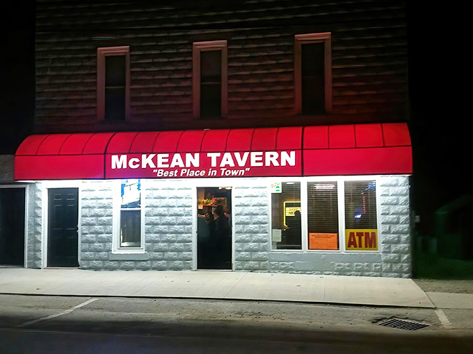 The iconic red awning of McKean Tavern glows like a beacon for hungry travelers. "Best Place in Town" isn't just a slogan—it's a promise.