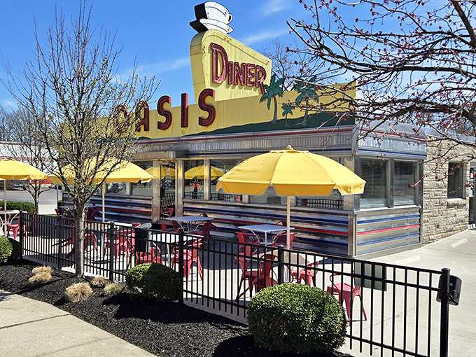 The sunshine-yellow facade of Oasis Diner gleams like a beacon of hope for hungry travelers on U.S. 40, promising comfort food salvation inside.