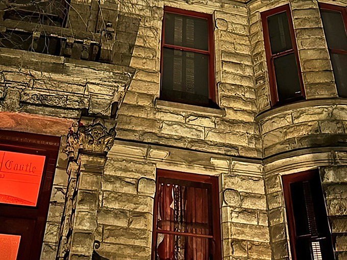 The iconic sandstone exterior with its distinctive red-trimmed windows makes Franklin Castle look like it's auditioning for a Tim Burton movie.