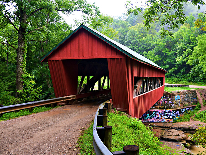 The classic red siding against autumn foliage creates nature's perfect color palette. This isn't just a bridge&mdash;it's a portal to simpler times.