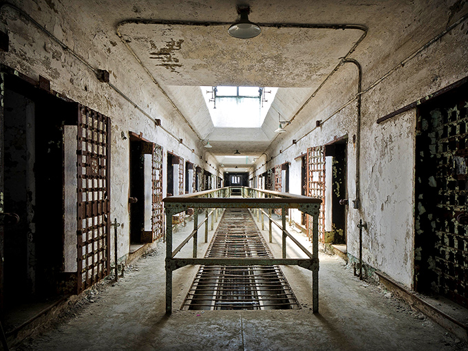 Cell Block 7 stretches into infinity like a dystopian cathedral. The peeling paint and crumbling walls tell stories that no prison documentary could ever capture.