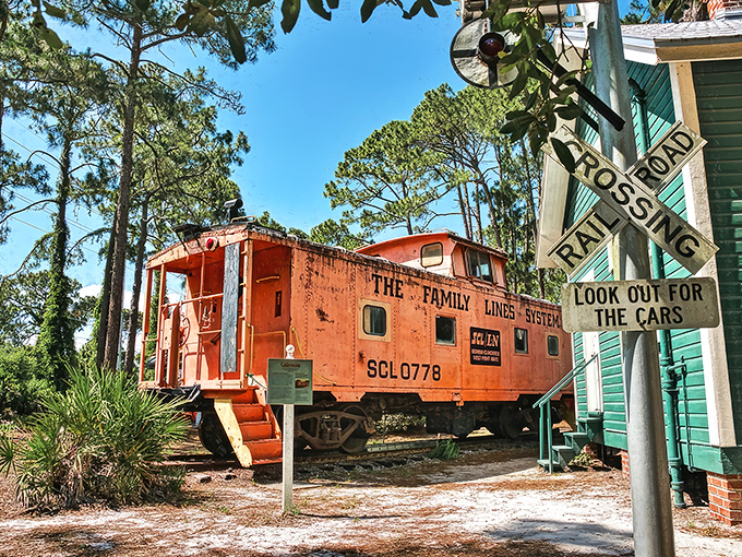 The bright orange Seaboard Air Line Railroad caboose stands out like a traffic cone at a black-tie dinner, offering visitors a glimpse into Florida's railroad history.
