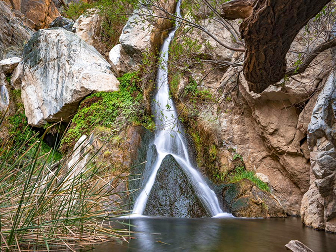 Nature's perfect contradiction: a pristine waterfall splitting rocky terrain like Moses parting the Red Sea, but with better landscaping.