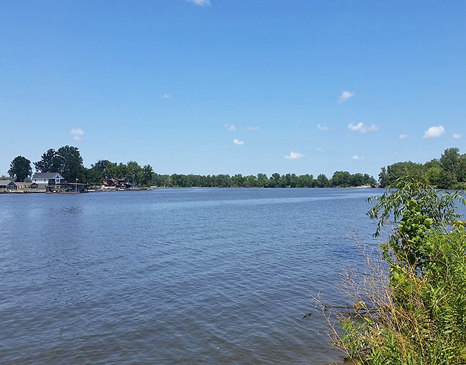 The vast blue expanse of Big Lake stretches to the horizon, offering a perfect mirror for Missouri's endless sky. Nature's own infinity pool.