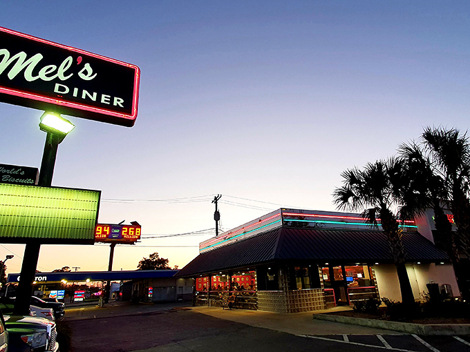 The neon sign beckons like an old friend against the Louisiana twilight. Mel's Diner stands ready to transport you to simpler times with extraordinary flavors.