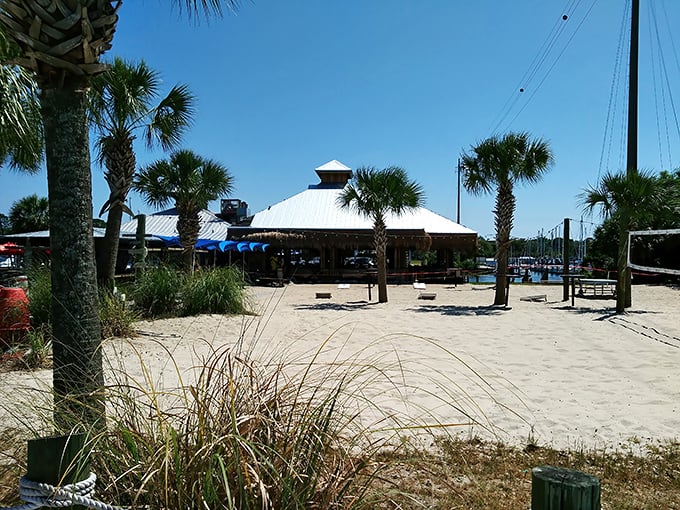 Paradise found! The Oar House's sandy approach and thatched roof tiki structure instantly signals you've discovered authentic Florida coastal living.