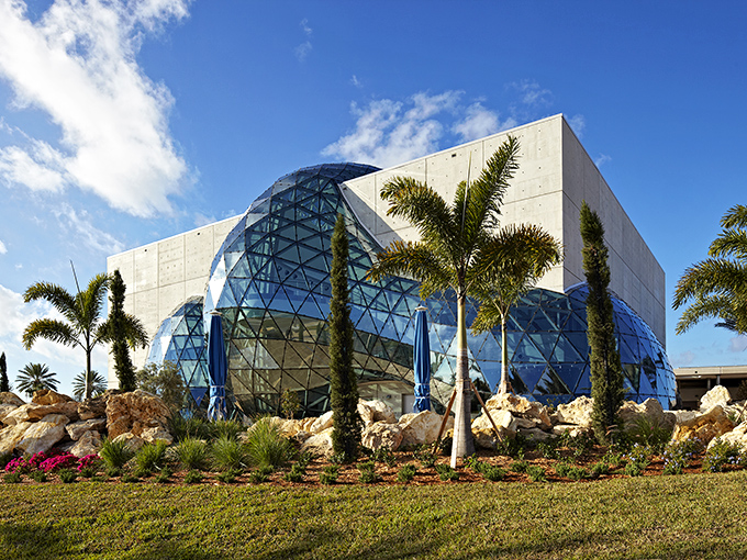 This glass bubble erupting from concrete looks like architecture having a very stylish nervous breakdown.