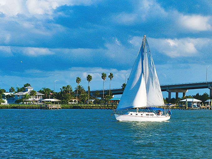 Sailboats drift through Edgewater's waters like floating retirement dreams with perfect weather year-round.