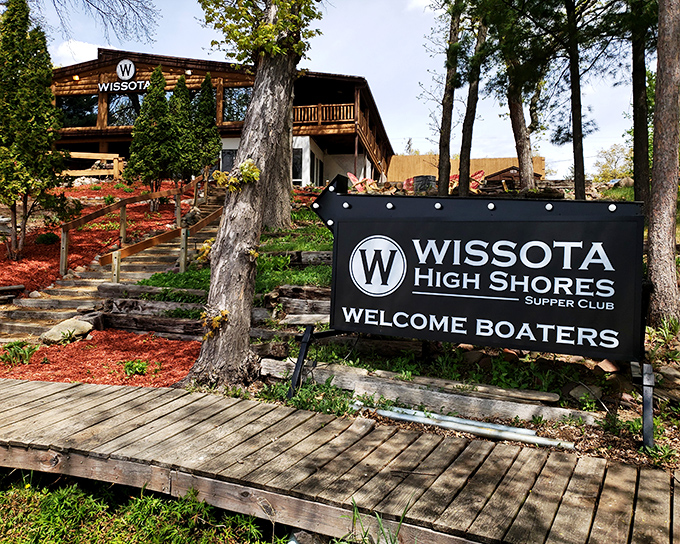 The rustic wooden exterior of Wissota High Shores welcomes boaters and landlubbers alike, promising lakeside dining that's worth the journey.
