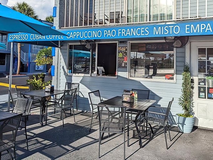 The bright blue awning of Express Cafe stands out like a culinary lighthouse, beckoning hungry travelers with promises of Cuban coffee and homemade delights.