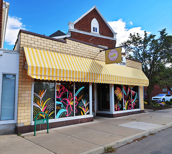 The cheerful yellow-striped awning of Butter Cafe beckons like a breakfast lighthouse, promising delicious refuge from ordinary morning meals.