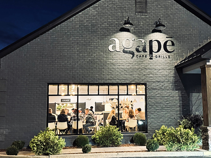 The sleek gray brick exterior glows with warmth at dusk, like a culinary lighthouse beckoning hungry travelers through Amish country.