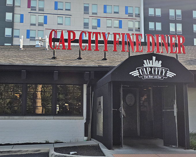 Daylight reveals Cap City's welcoming facade—where the promise of upscale diner fare awaits just beyond those black-trimmed doors.