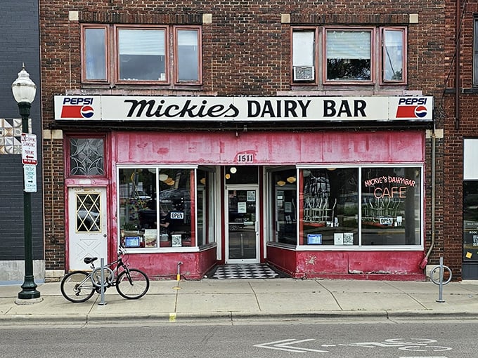 The iconic pink facade of Mickey's Dairy Bar stands defiant against Wisconsin winter, a warm beacon promising comfort food when you need it most.