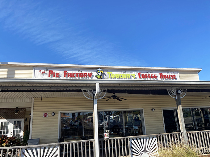 The Pie Factory's cheerful exterior beckons like an old friend inviting you over for dessert. That porch practically whispers, "Stay awhile, calories don't count here."