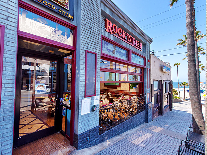 The iconic blue-bricked facade of Rock'N Fish stands out like a maritime jewel on Manhattan Beach, promising seafood treasures just steps from the Pacific.