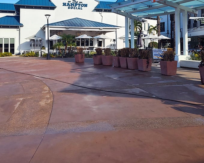 The Hampton Social's pristine white exterior with blue accents isn't just a building&mdash;it's a promise of coastal elegance waiting just beyond those doors.