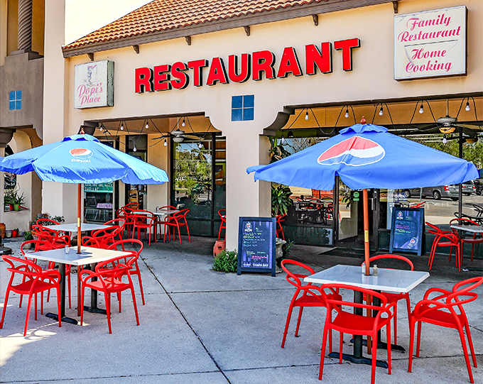 The welcoming facade of Popi's Place in Bradenton, where those cheerful red chairs practically beg you to sit down and stay awhile.
