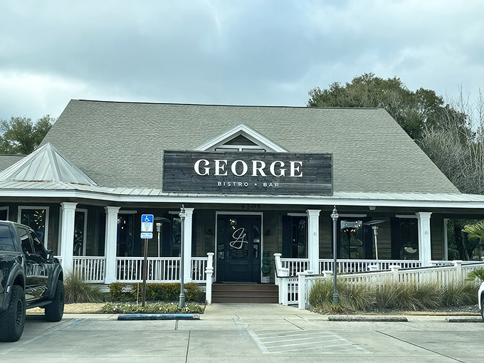 George Bistro + Bar's charming facade welcomes you with classic Southern architecture and a wraparound porch that practically whispers "come sit a spell."