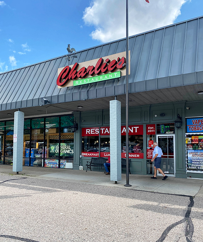 The iconic red script of Charlie's Restaurant beckons hungry travelers like a culinary lighthouse in this Madison Heights strip mall.