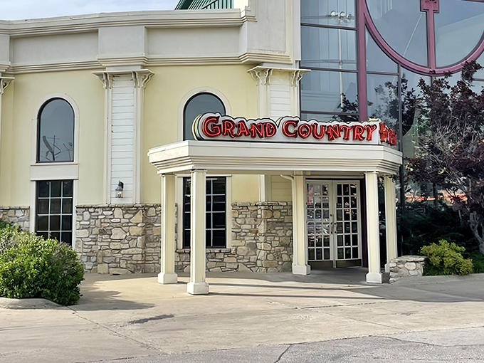 The welcoming facade of Grand Country Buffet beckons hungry travelers with its stone columns and bold signage&mdash;like a beacon of comfort food in Branson's entertainment landscape.