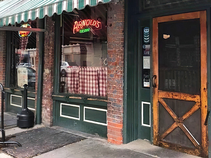 The wooden door with its X-frame design isn't just an entrance &ndash; it's a time portal to Cincinnati's most cherished dining institution.