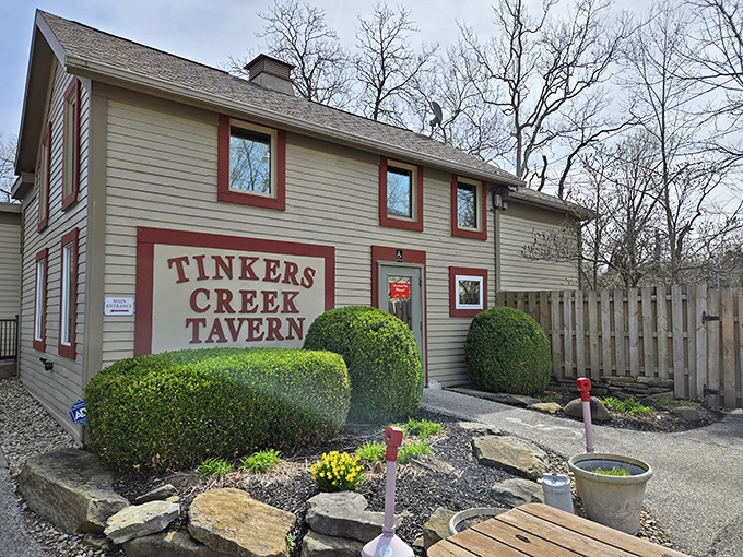 Perfectly manicured shrubs frame this charming tavern, where the sign boldly announces what locals already know &ndash; you've found a hidden gem.