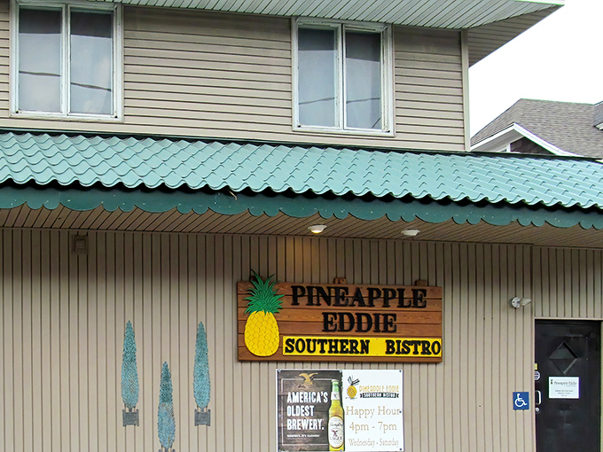 The teal-trimmed roof and cheerful pineapple sign of Pineapple Eddie Southern Bistro beckon hungry travelers like a Southern lighthouse in Erie's culinary landscape. 
