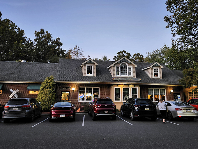 The charming Cape Cod-style exterior of Moccia's Train Stop beckons hungry travelers with its warm lights and railroad crossing sign &ndash; a delicious destination worth the journey.