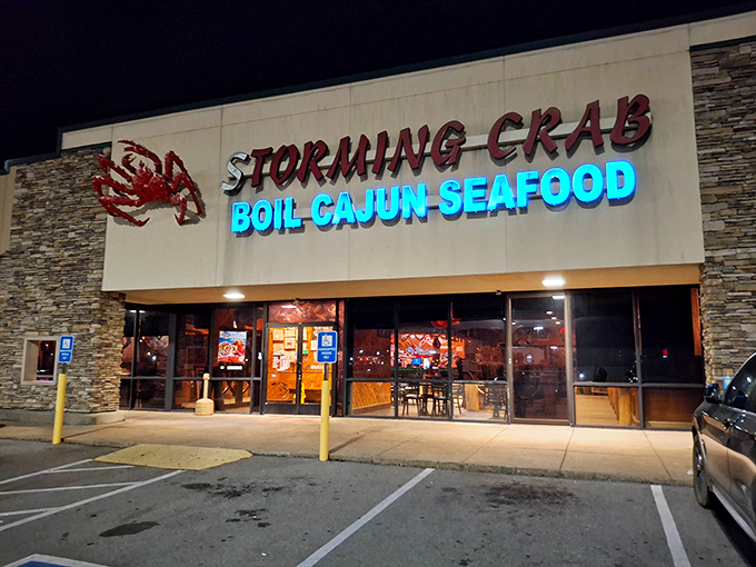 The neon blue "BOIL-CAJUN-SEAFOOD" sign glows like a lighthouse beacon for hungry seafood lovers, promising delicious treasures within these stone-faced walls.