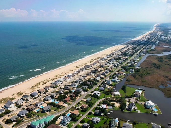 Aerial paradise revealed: Sandbridge stretches like nature's perfect compromise between civilization and wilderness, with the Atlantic on one side and Back Bay on the other.