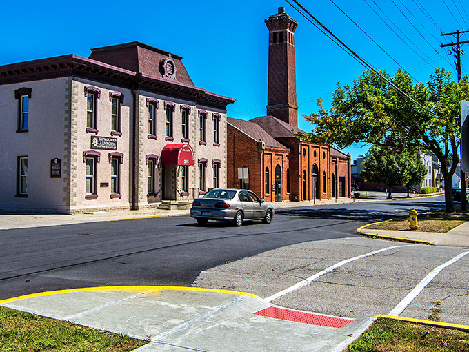 This stretch of Main Street showcases Troy's architectural heritage, with that impressive brick chimney standing like a sentinel over the neighborhood.