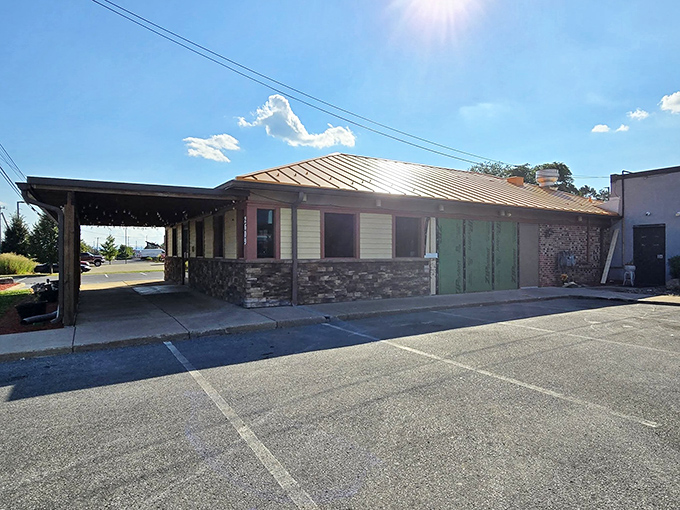 Bathed in golden sunlight, this side view reveals the restaurant's stone foundation &ndash; solid as the BBQ principles practiced inside.