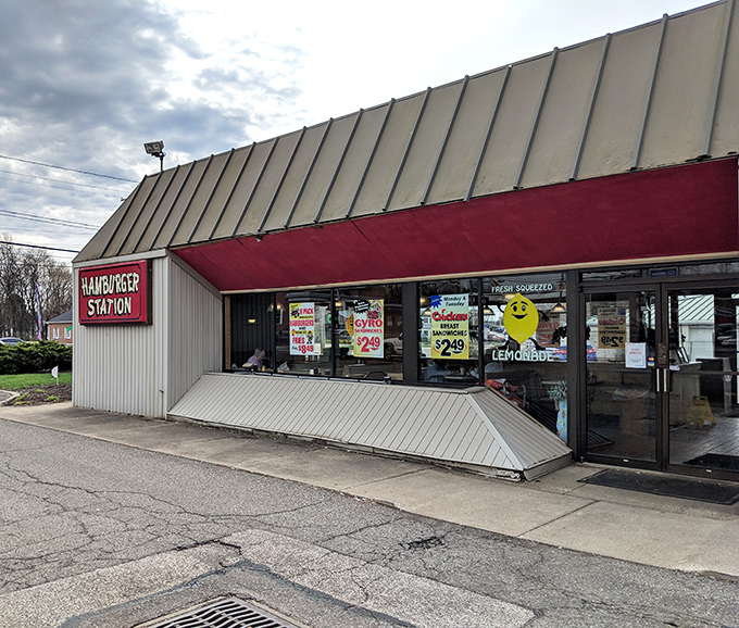 The iconic red sign beckons like a lighthouse for the burger-obsessed. This unassuming exterior houses flavor that's anything but modest.