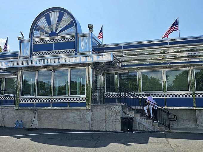 The gleaming blue and chrome exterior of Blue Colony Diner stands like a time machine on wheels, permanently parked in Newtown for your dining pleasure.