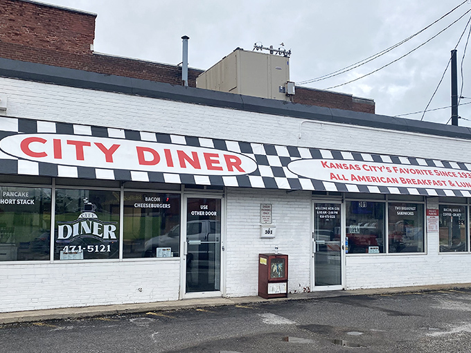 The classic black and white checkerboard trim frames City Diner's bold red signage like a culinary chess match where everyone wins&mdash;especially your appetite.