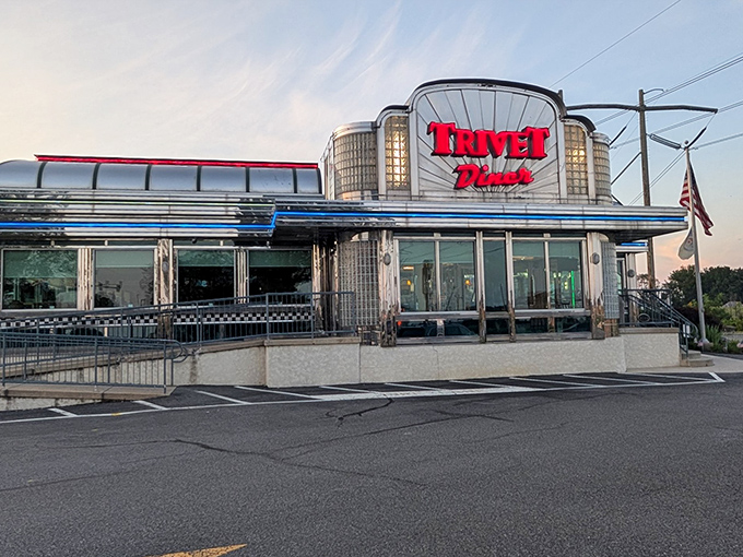 The gleaming chrome exterior of Trivet Diner stands like a time machine to America's golden age of roadside dining, complete with that iconic red signage.