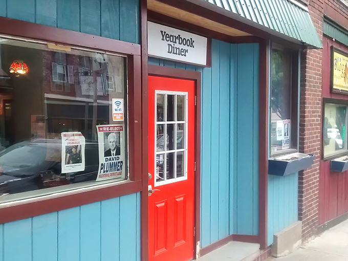 That bright orange door against the blue exterior isn't just eye-catching&mdash;it's practically shouting "Come in, happiness served all day!" Small-town charm at its finest.