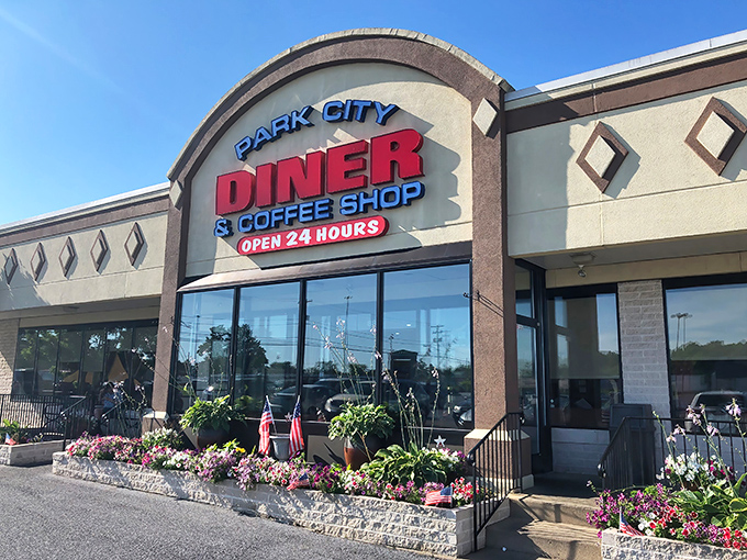 The welcoming facade of Park City Diner stands like a beacon for hungry travelers, its colorful flower beds promising the same attention to detail you'll find inside.