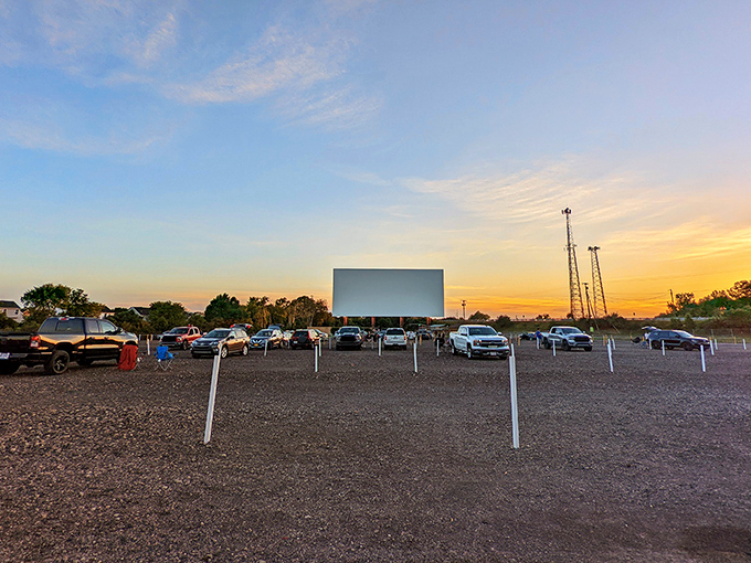 The perfect Ohio evening unfolds as the massive screen awaits its first flicker of light, while cars claim their spots in this gravel ballroom of cinema.
